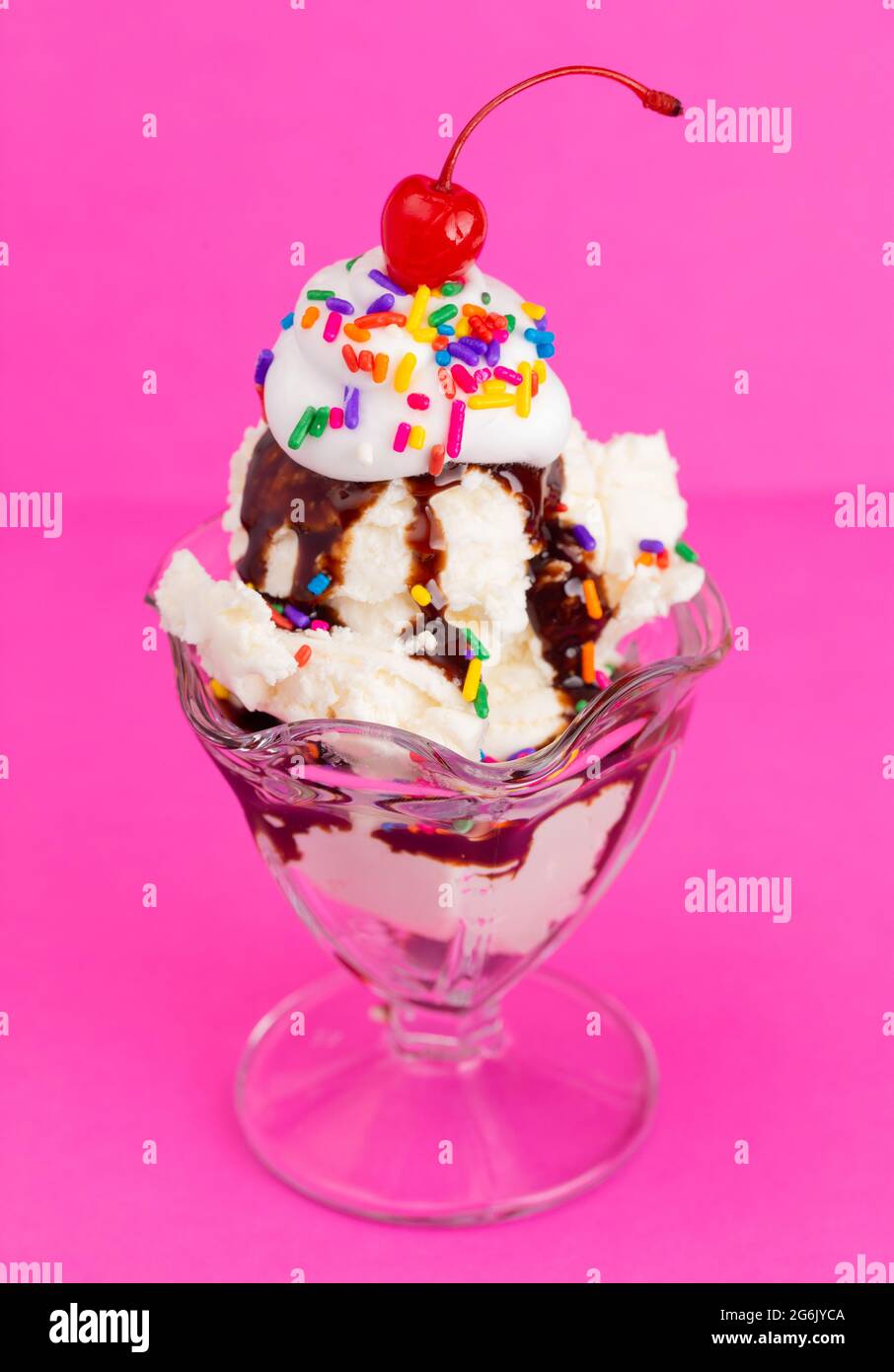 Vanilla Sundae with Sprinkles and Chocolate Sauce on a Pink Background ...