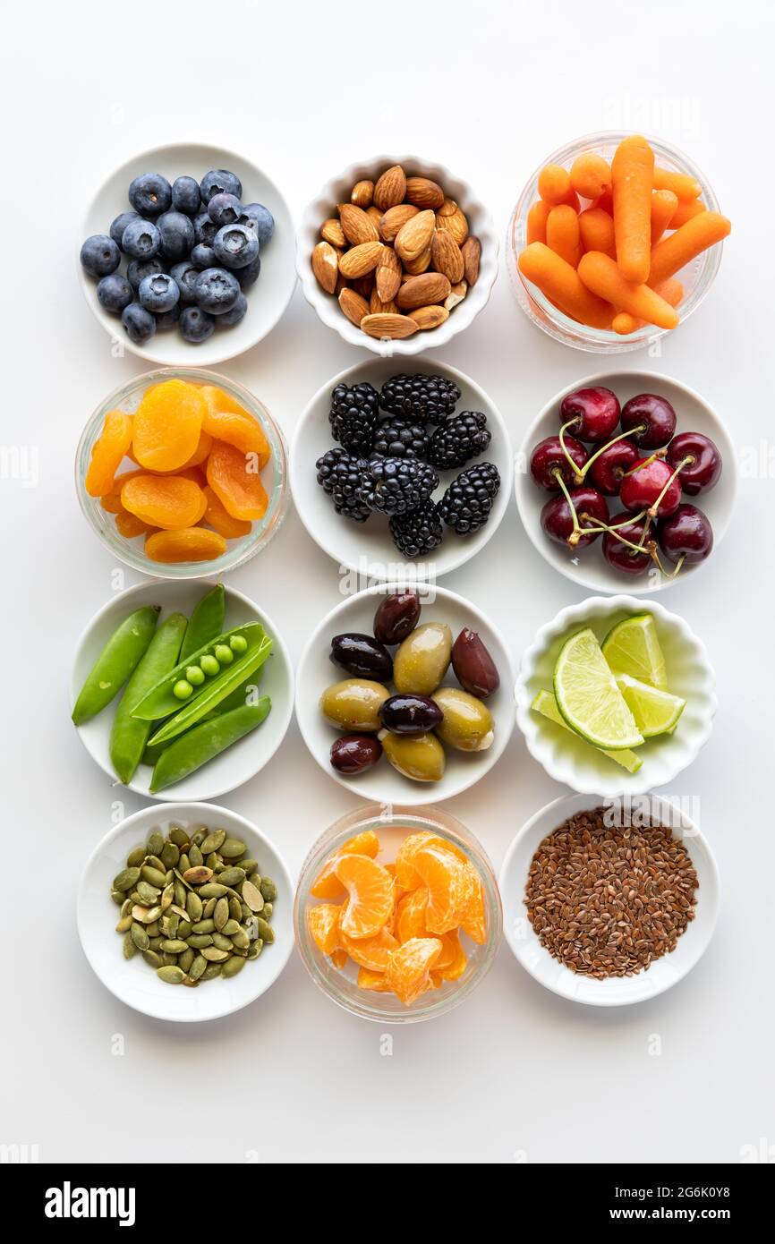 Many various fresh organic ingredients in small dishes against a bright ...