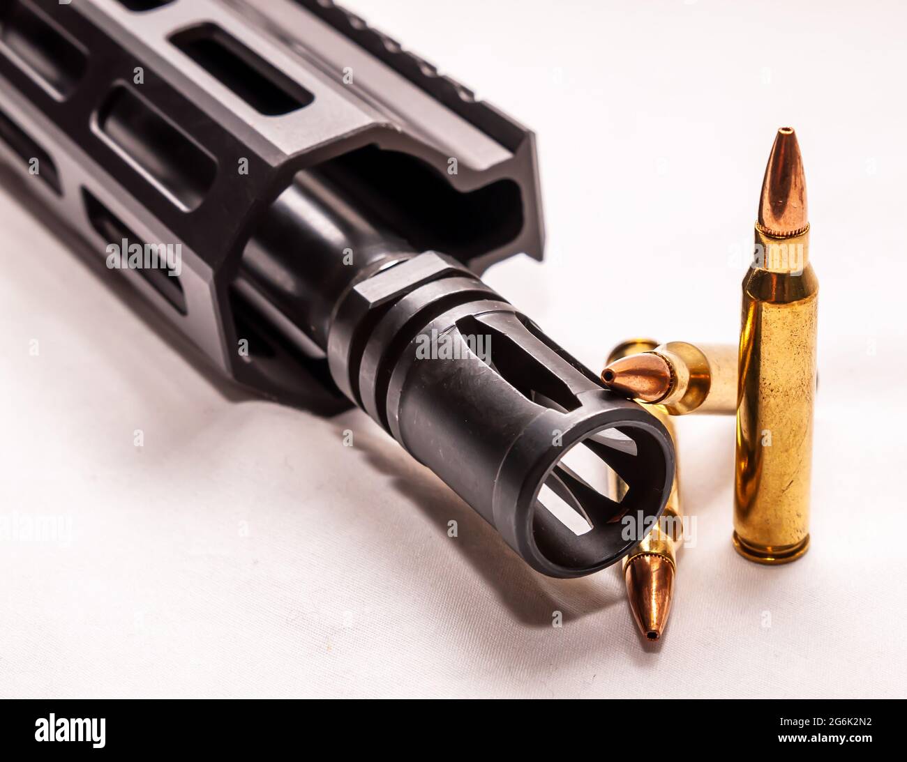 The barrel and muzzle of a 223 caliber rifle with three bullets for it ...