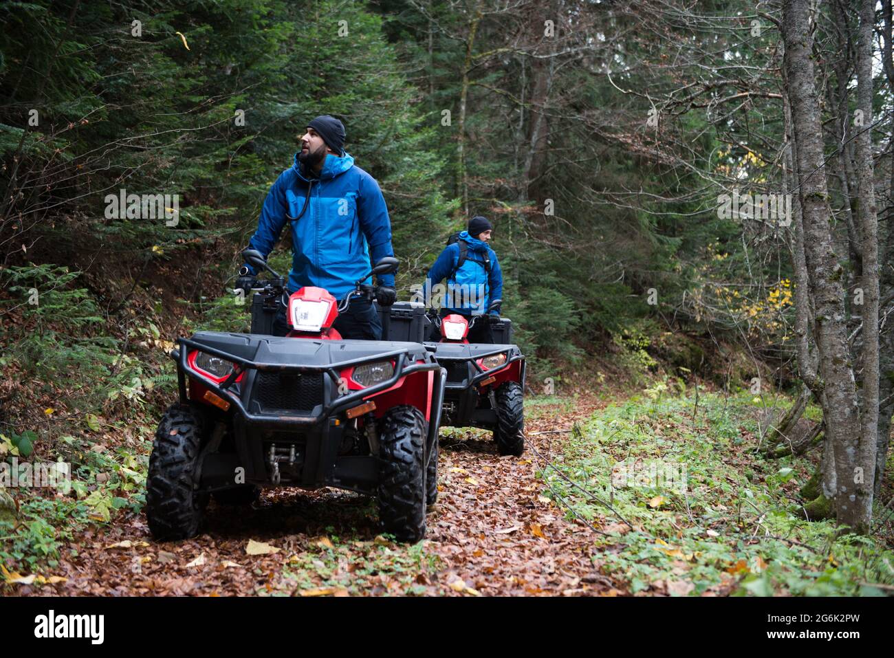 Rescuers in Protective Uniform on a Quad Bike Observe the Woods to ...