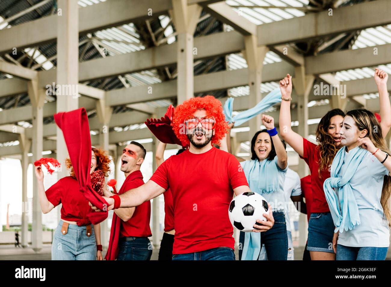 Happy multiracial fans having fun together outside of stadium Stock ...