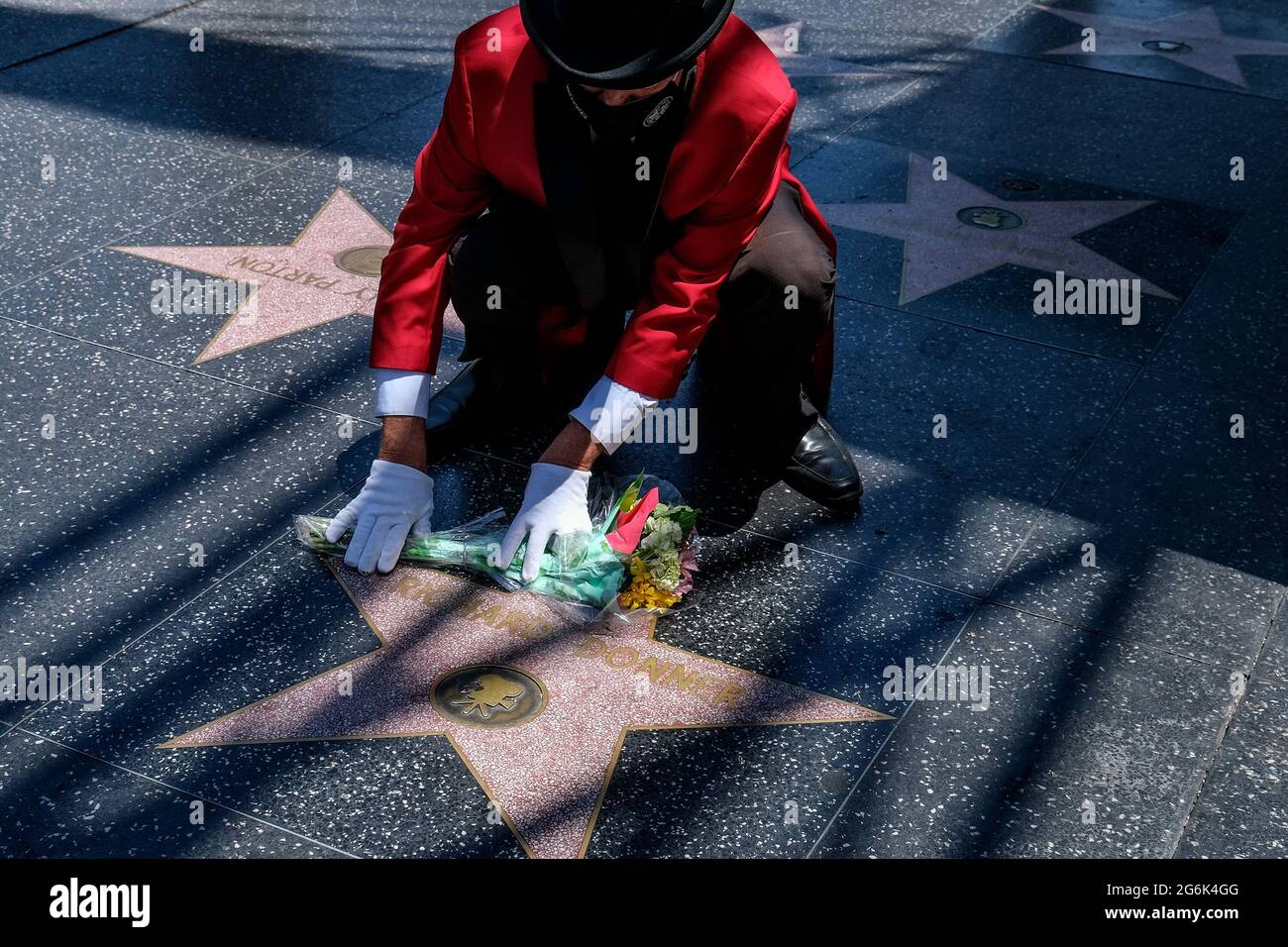 July 6, 2021, Los Angeles, California, USA: GREG DONOVAN places flowers ...
