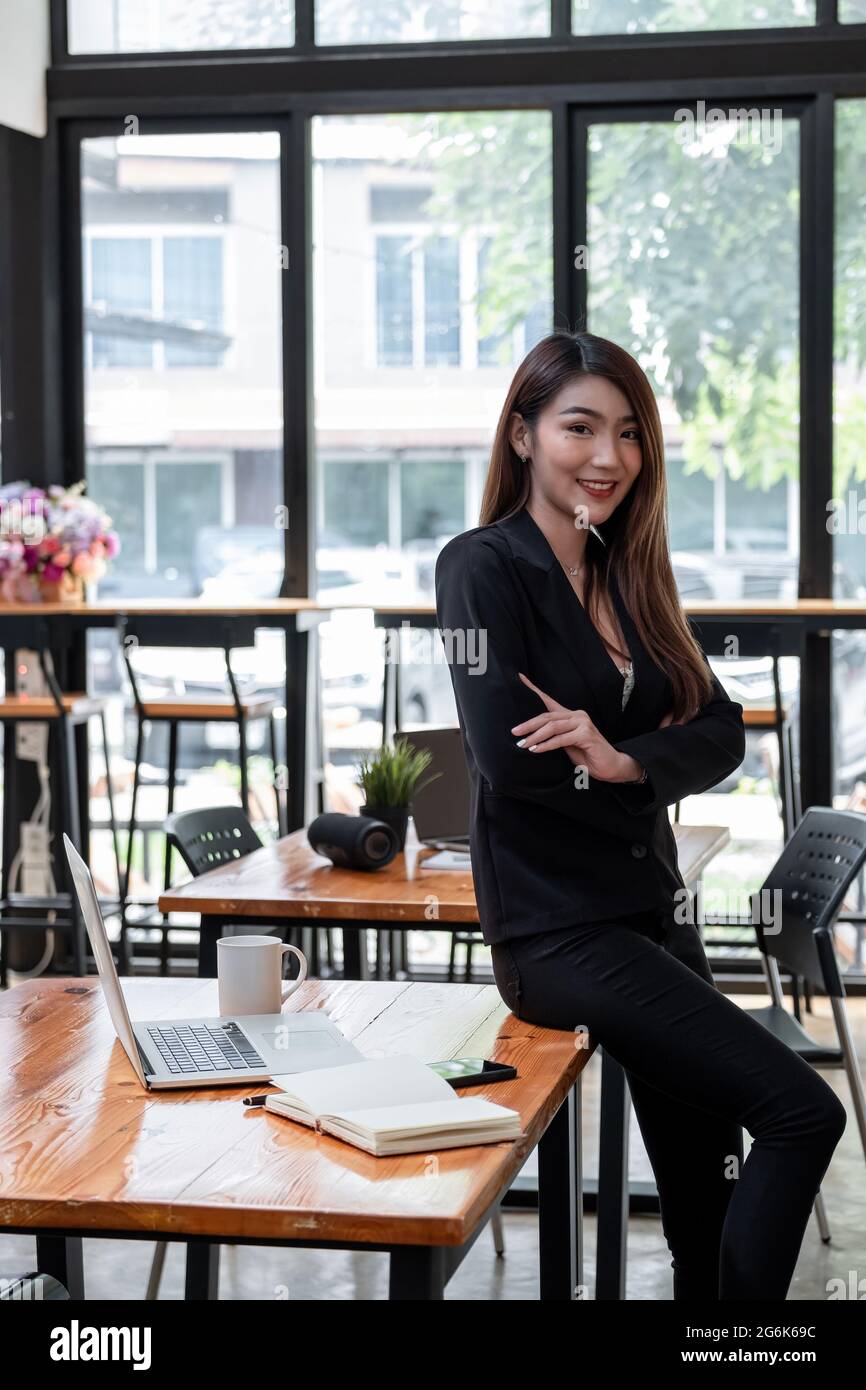 Image of a charming young Asian businesswoman standing at the office ...