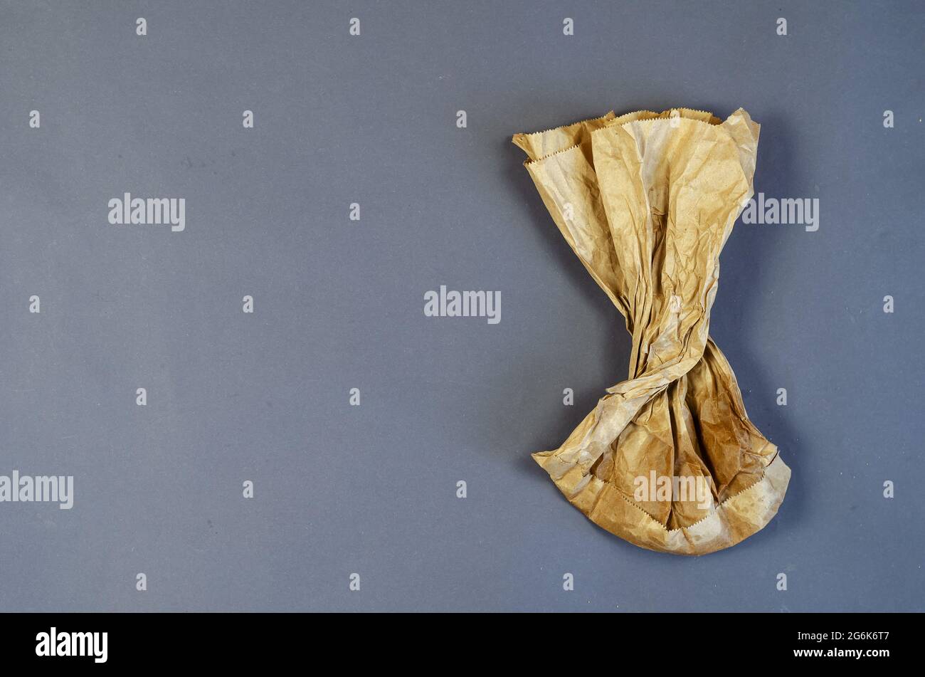 Twisted Dirty brown paper bag on gray background. Paper bag used for ...
