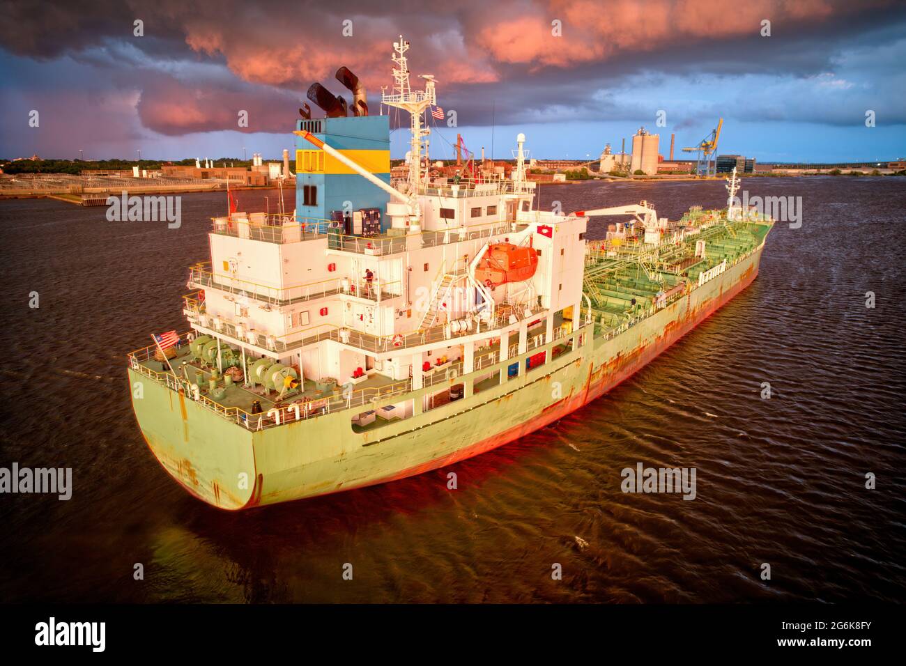 Cargo Ship on River with Intense Clouds Stock Photo - Alamy