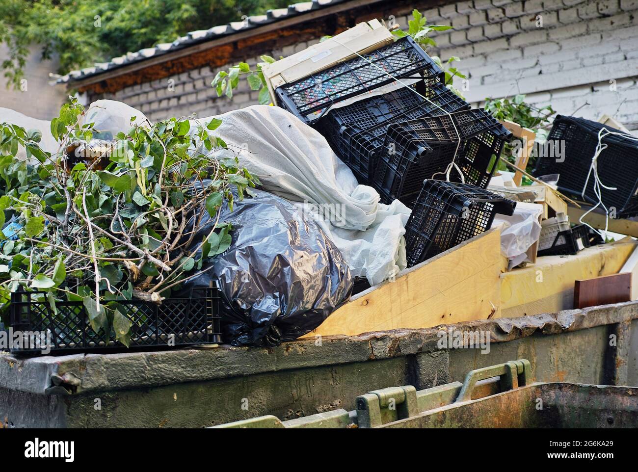 A pile of unsorted garbage in outdoor metal container Stock Photo - Alamy