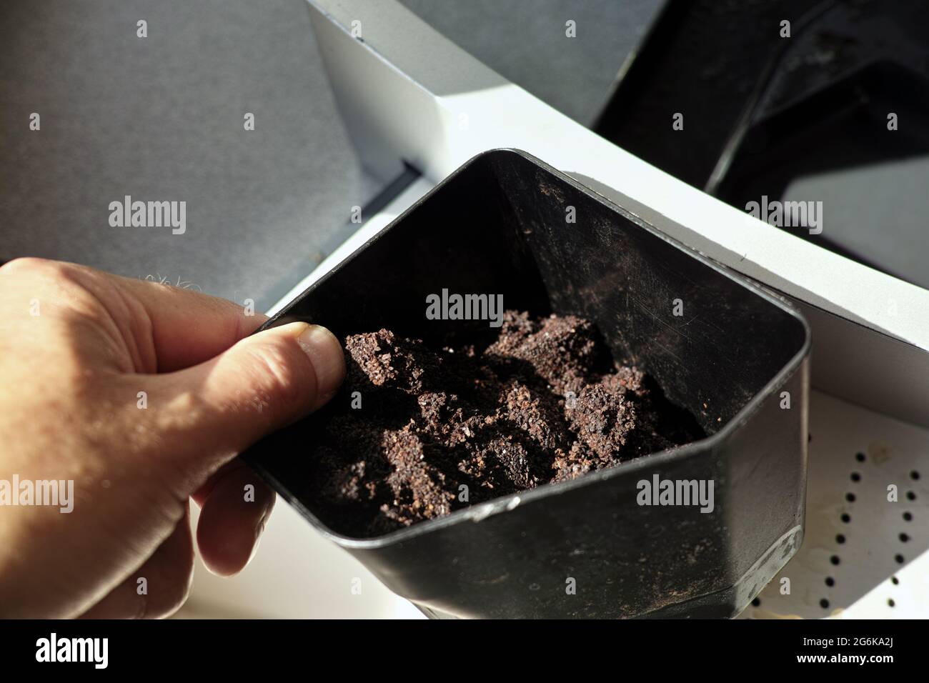 closeup of a hand, removing a coffee machine tray for cleaning Stock ...
