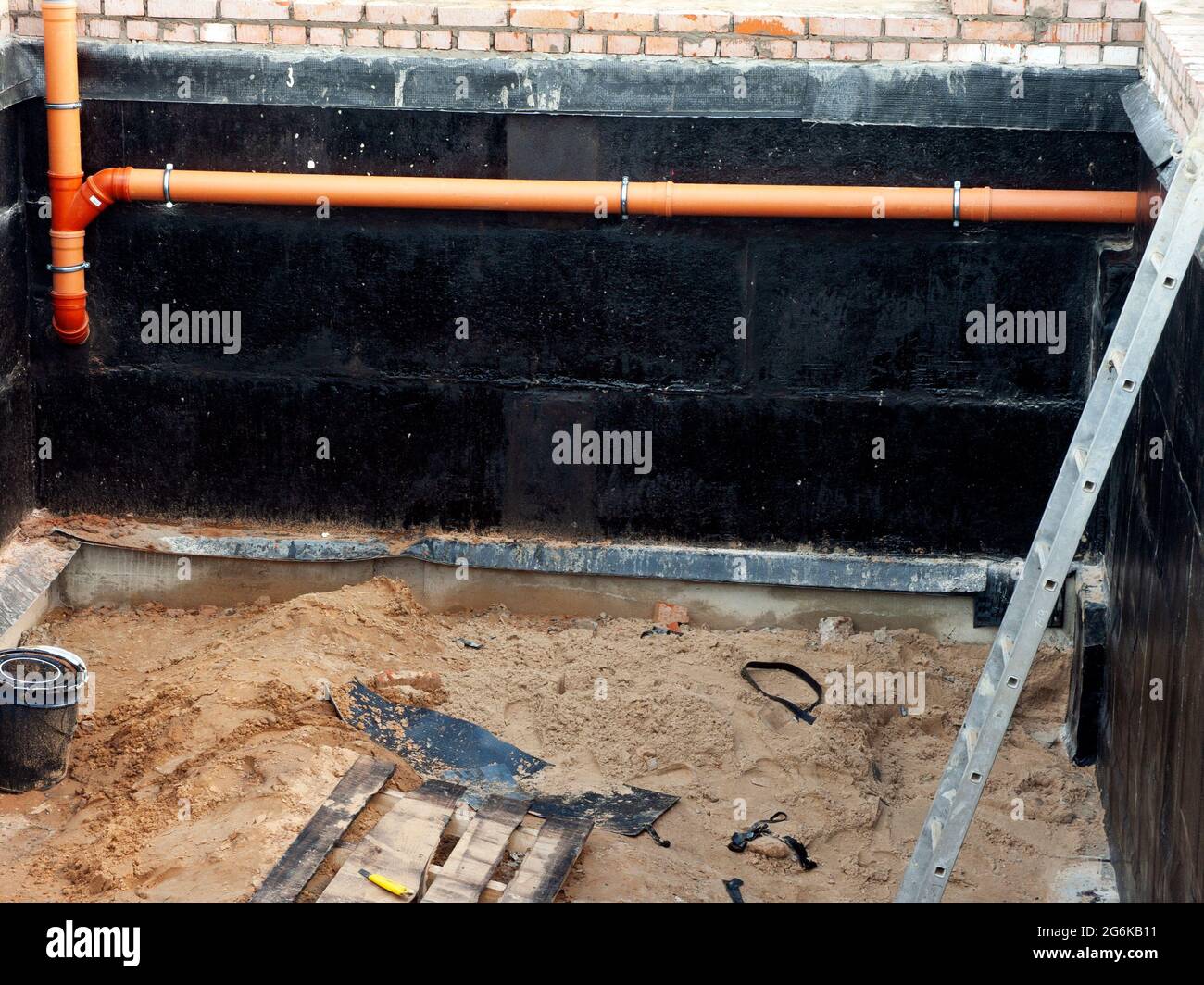 Waterproofing of a basement and sewage pipes, outdoor shot Stock Photo ...