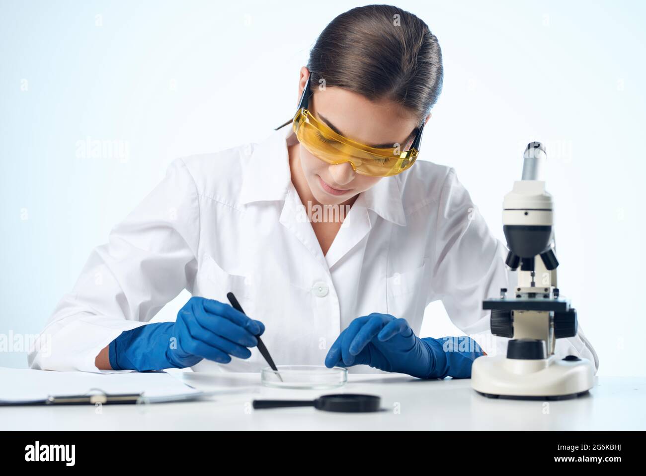 Woman in white coat laboratory microscope research biotechnology Stock ...
