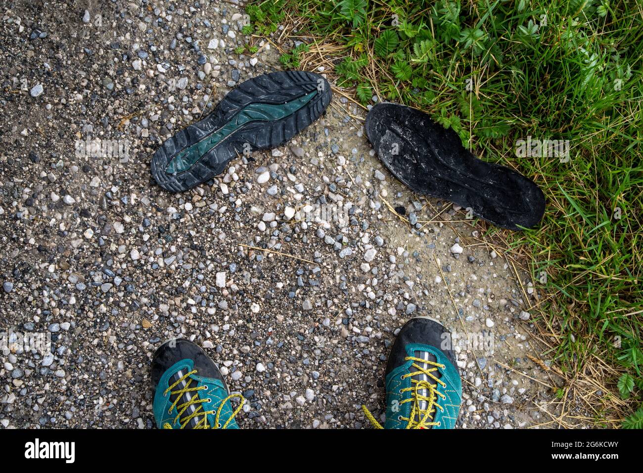 View of the floor with two shoes at the bottom and two detached shoe ...