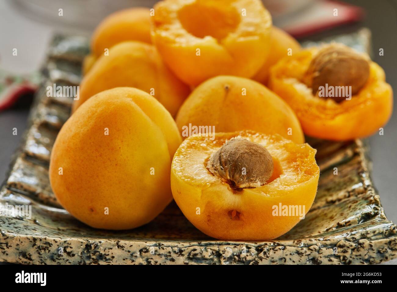 Fresh apricots whole and cut in half with seeds, ready to eat Stock ...