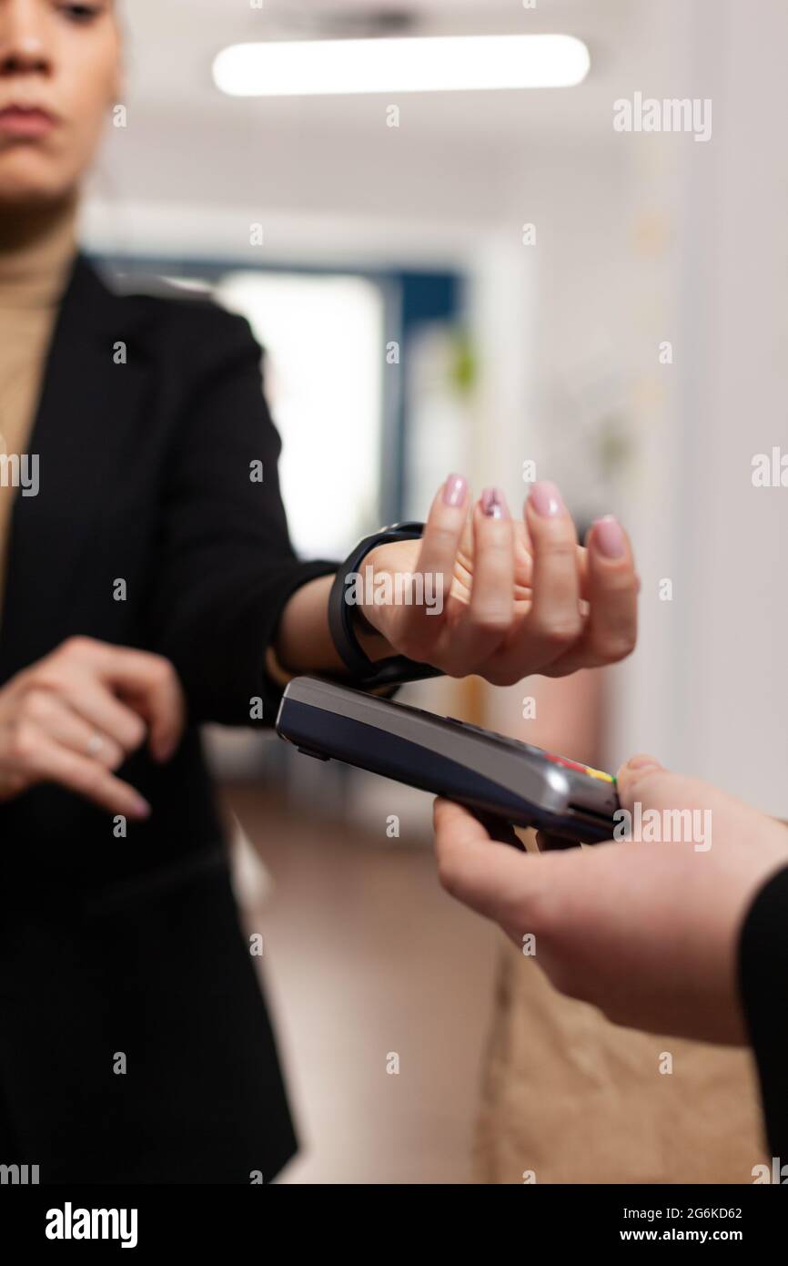 Woman entrepreneur in building office using contactless payment of ...