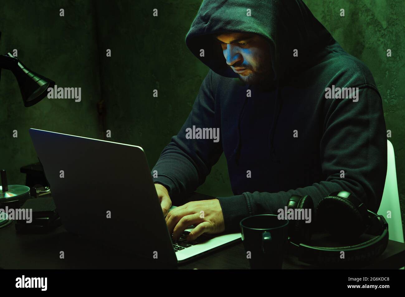 Hacker programmer using computer in dark room Stock Photo - Alamy