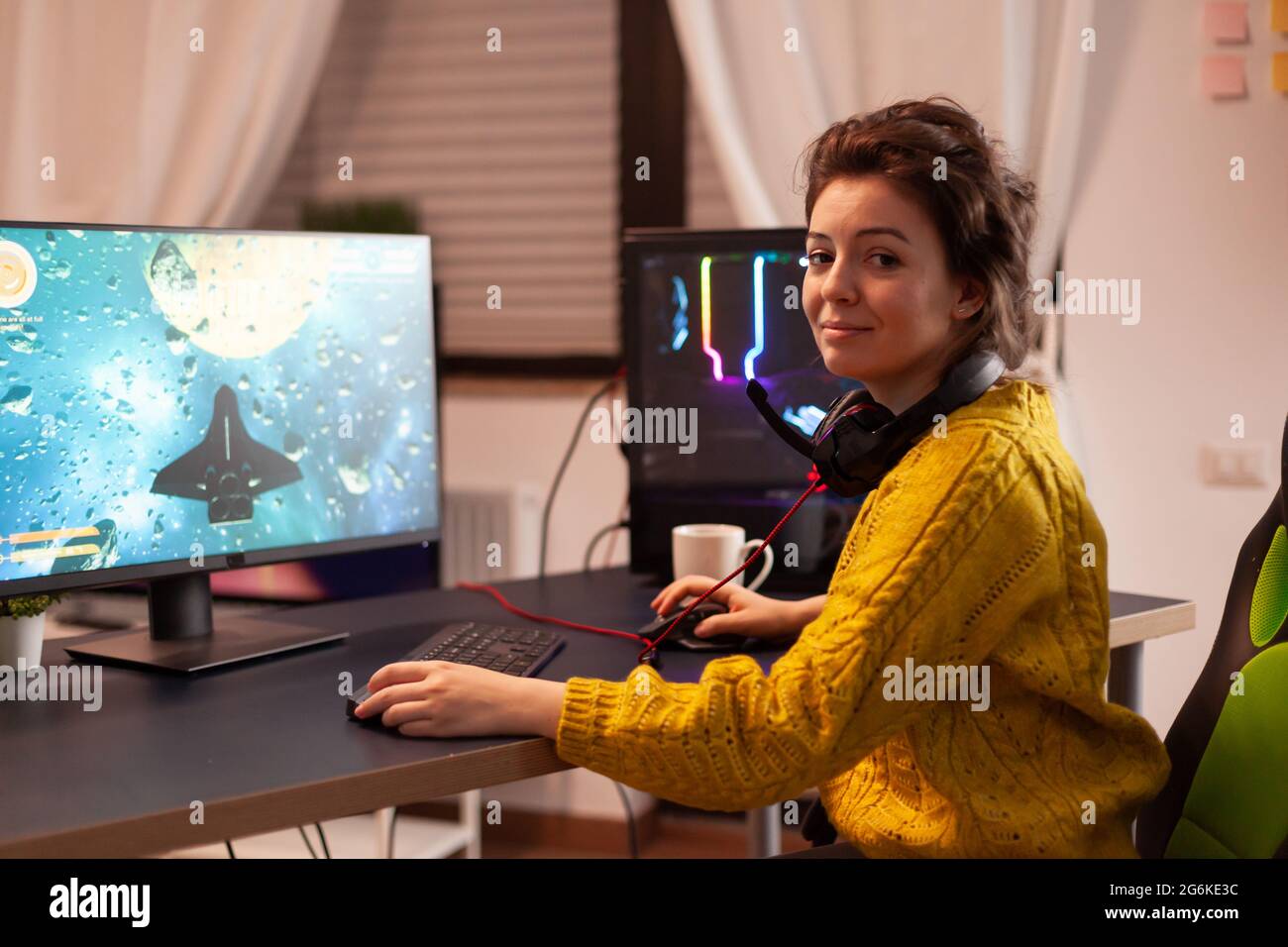 Professional esport woman gamer smiling at camera while compete in ...