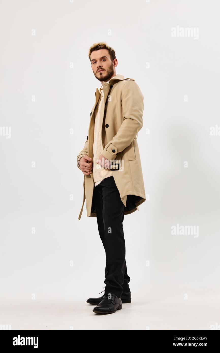 man in beige coat fashion modern style side view full length Stock ...