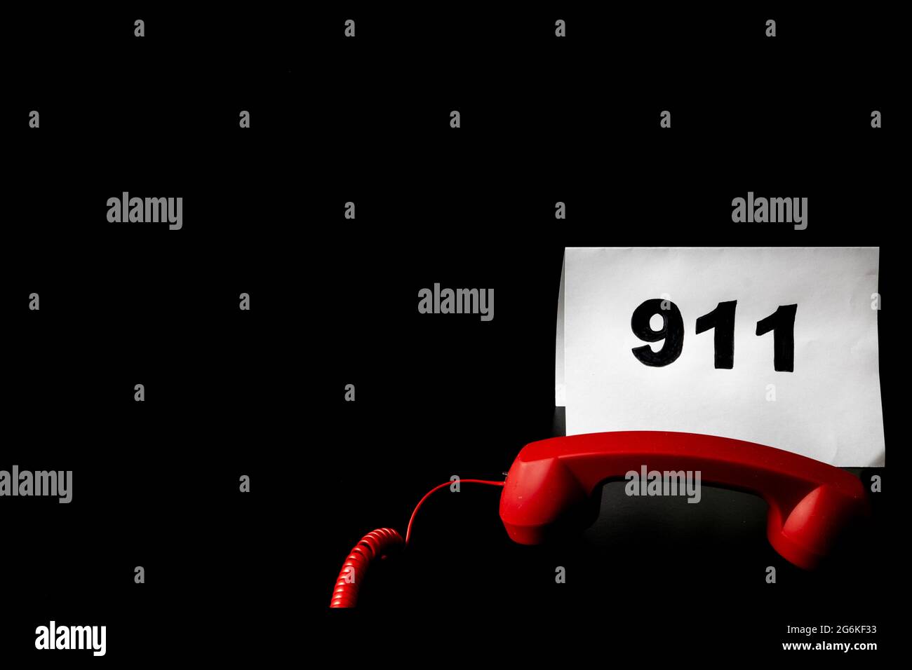 Emergency call concept, the text 911 on paper and telephone isolated on ...