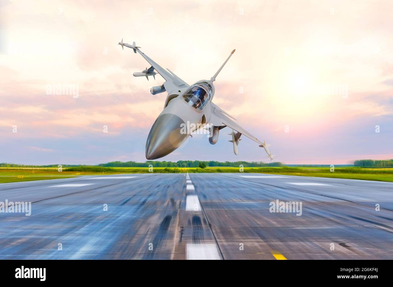 Military fighter jet flies at high speed over the taxiway at the ...