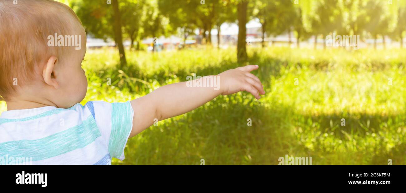 Little boy points somewhere in park. Banner Stock Photo - Alamy