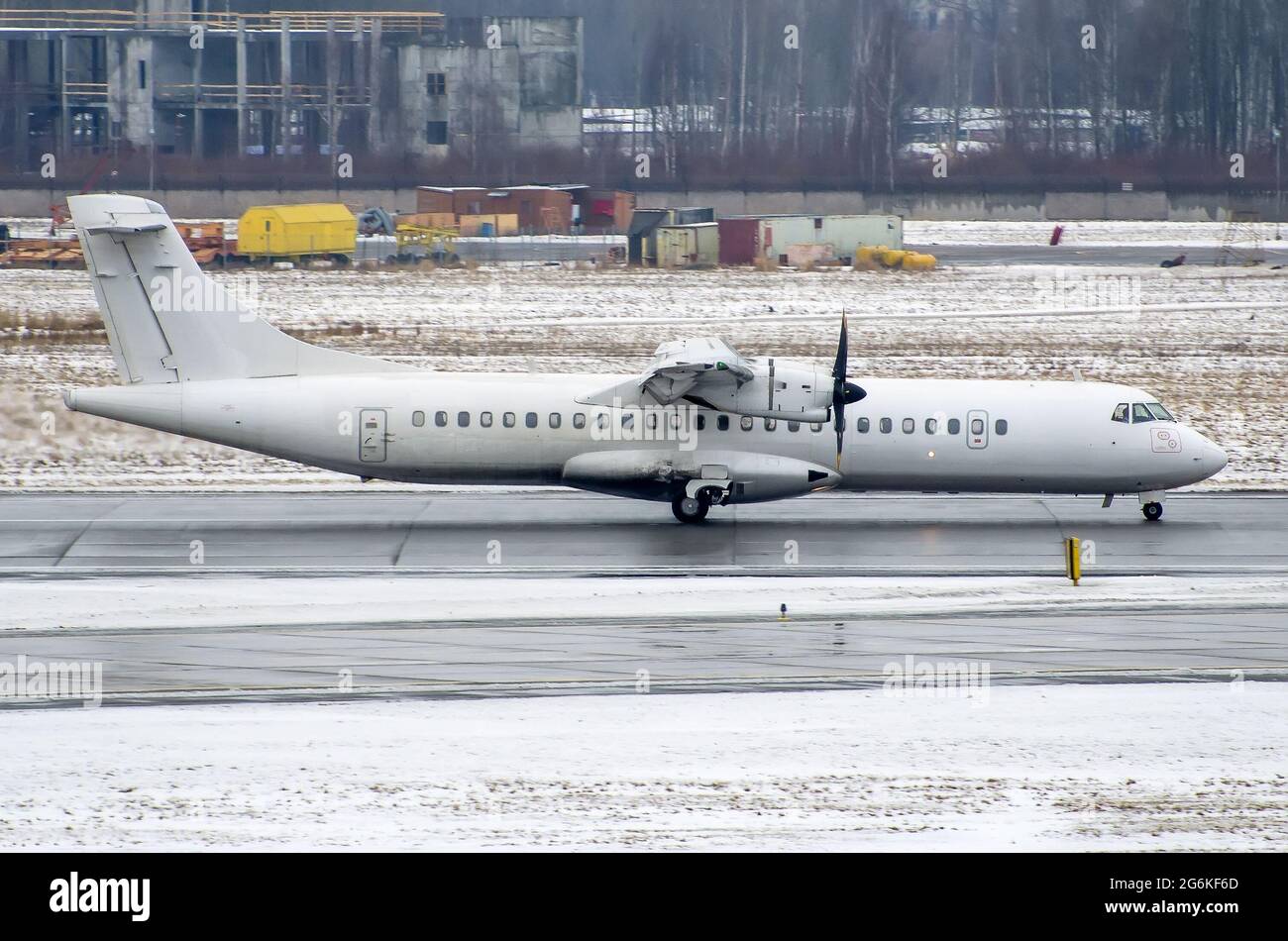 Passenger small airplane at the airport in winter in bad snow and ...