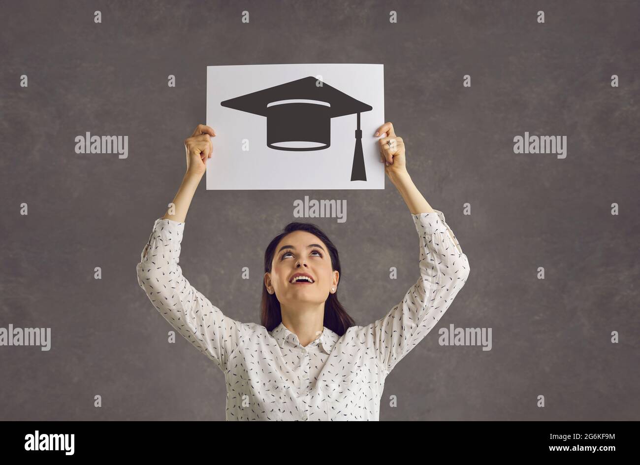 Happy student hoping to get university education holding image of ...