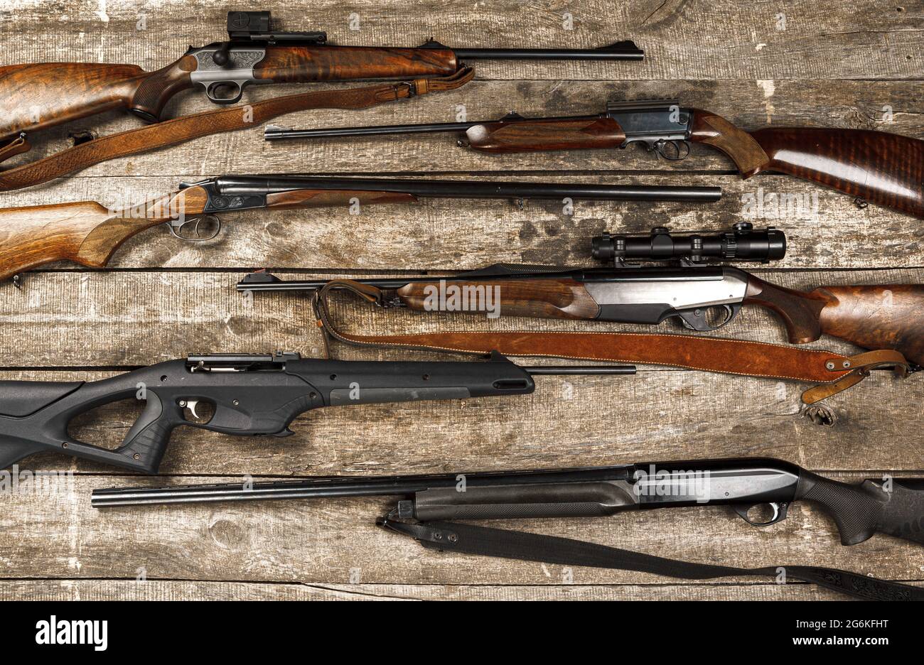 Many hunting rifles on weathered wooden surface Stock Photo - Alamy