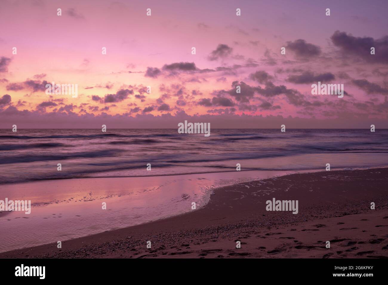 Seascape in the early morning. Sunrise on a sandy beach with beautiful ...