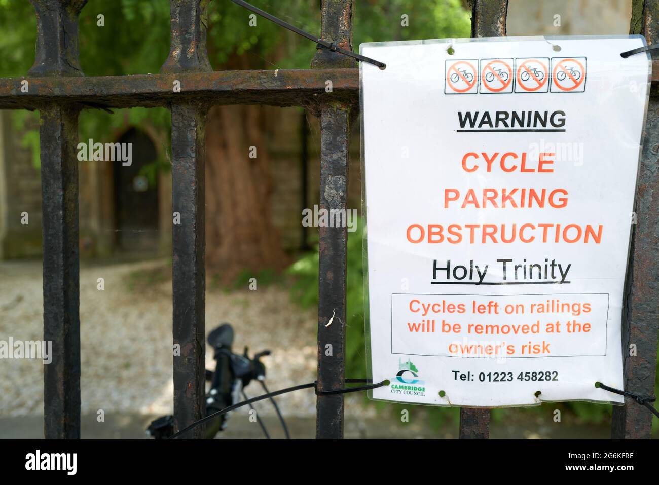 Warning notice about cycle parking obstruction on the railings outside ...
