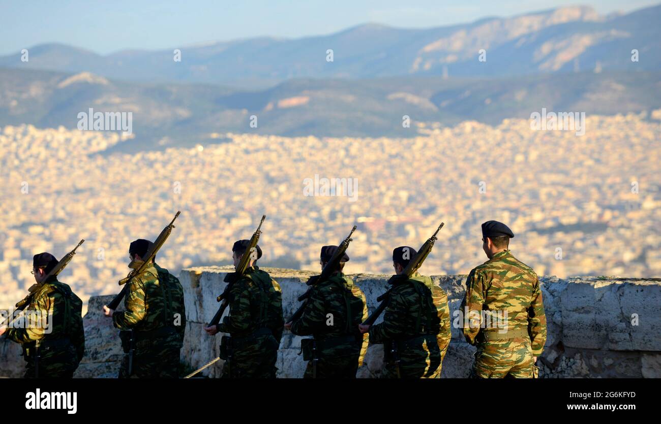 Greek soldiers marching down from the Acropolis after the Greek flag ...