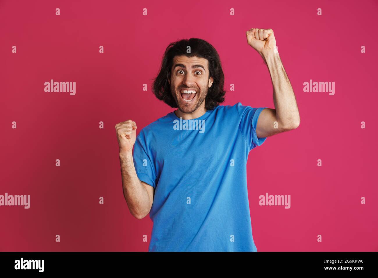 Excited brunette man screaming and making winner gesture isolated over ...
