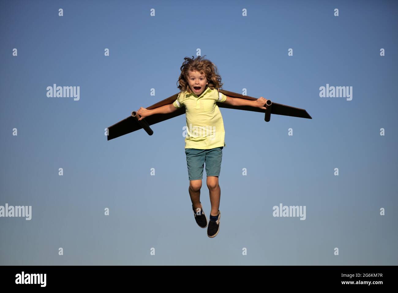 Child to be pilot. Kid with paper wings flying. Summer vacation and ...