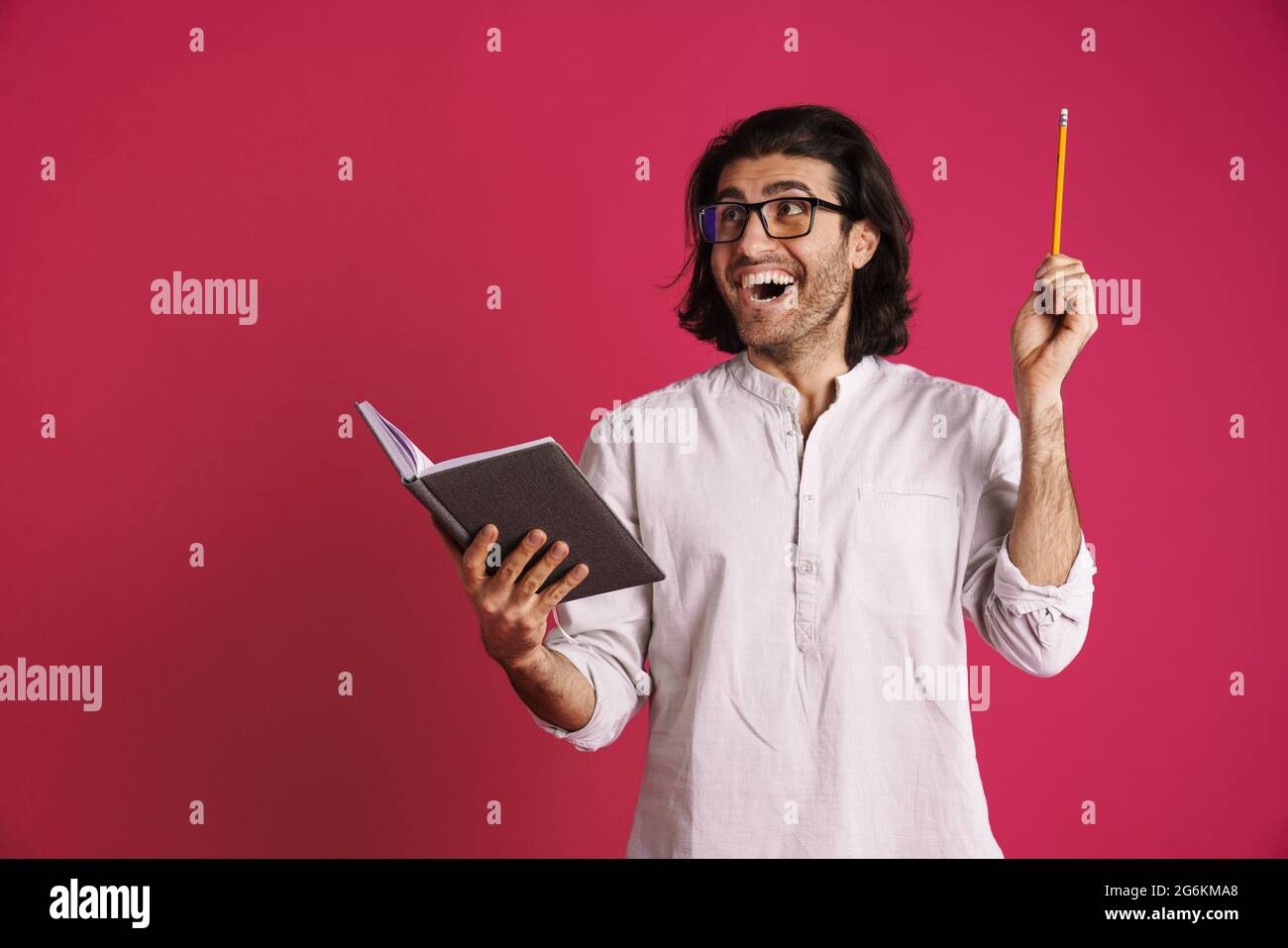 White excited man in eyeglasses exclaiming while writing down notes ...