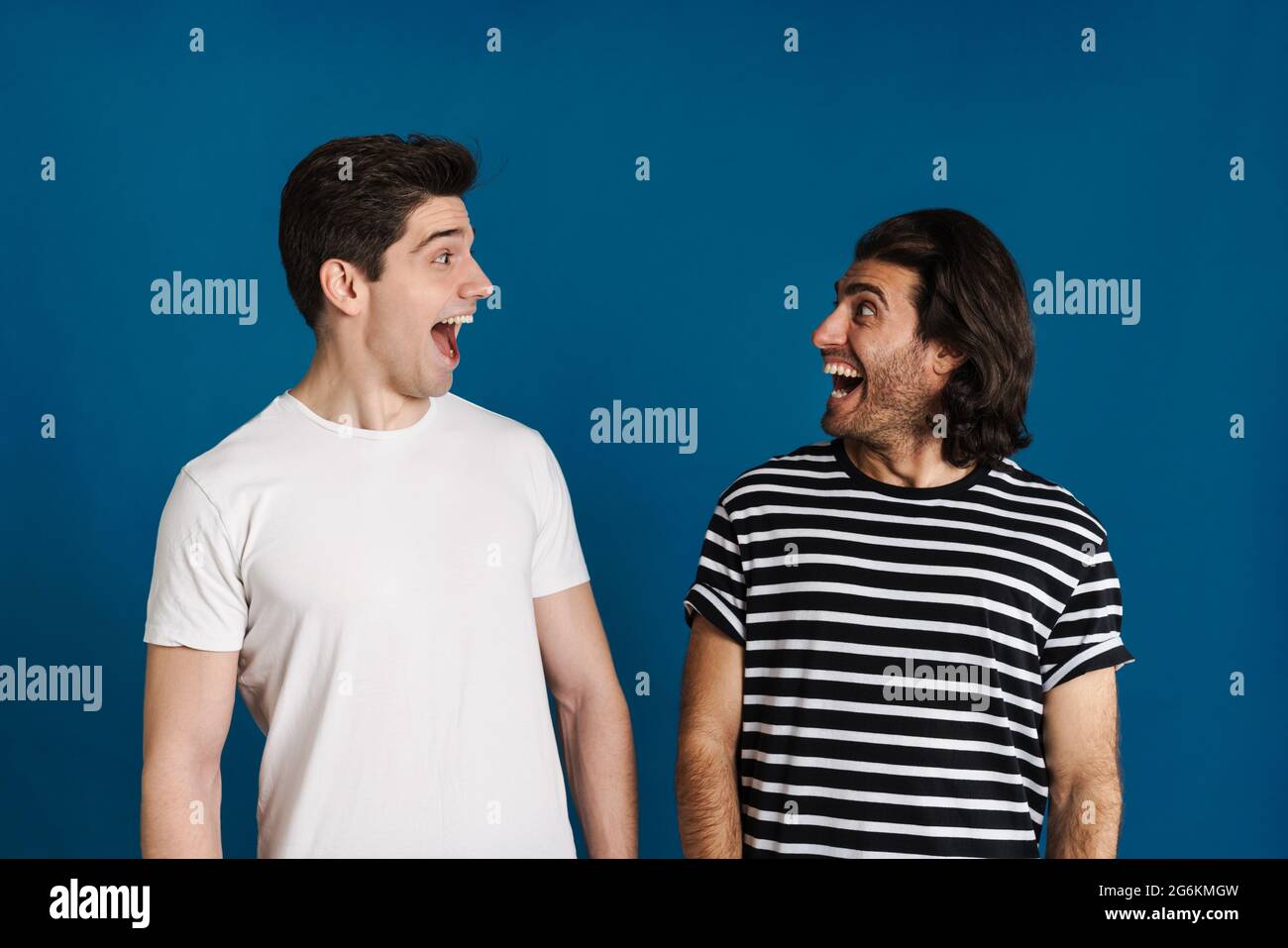 White excited two men exclaiming and looking at each other isolated ...