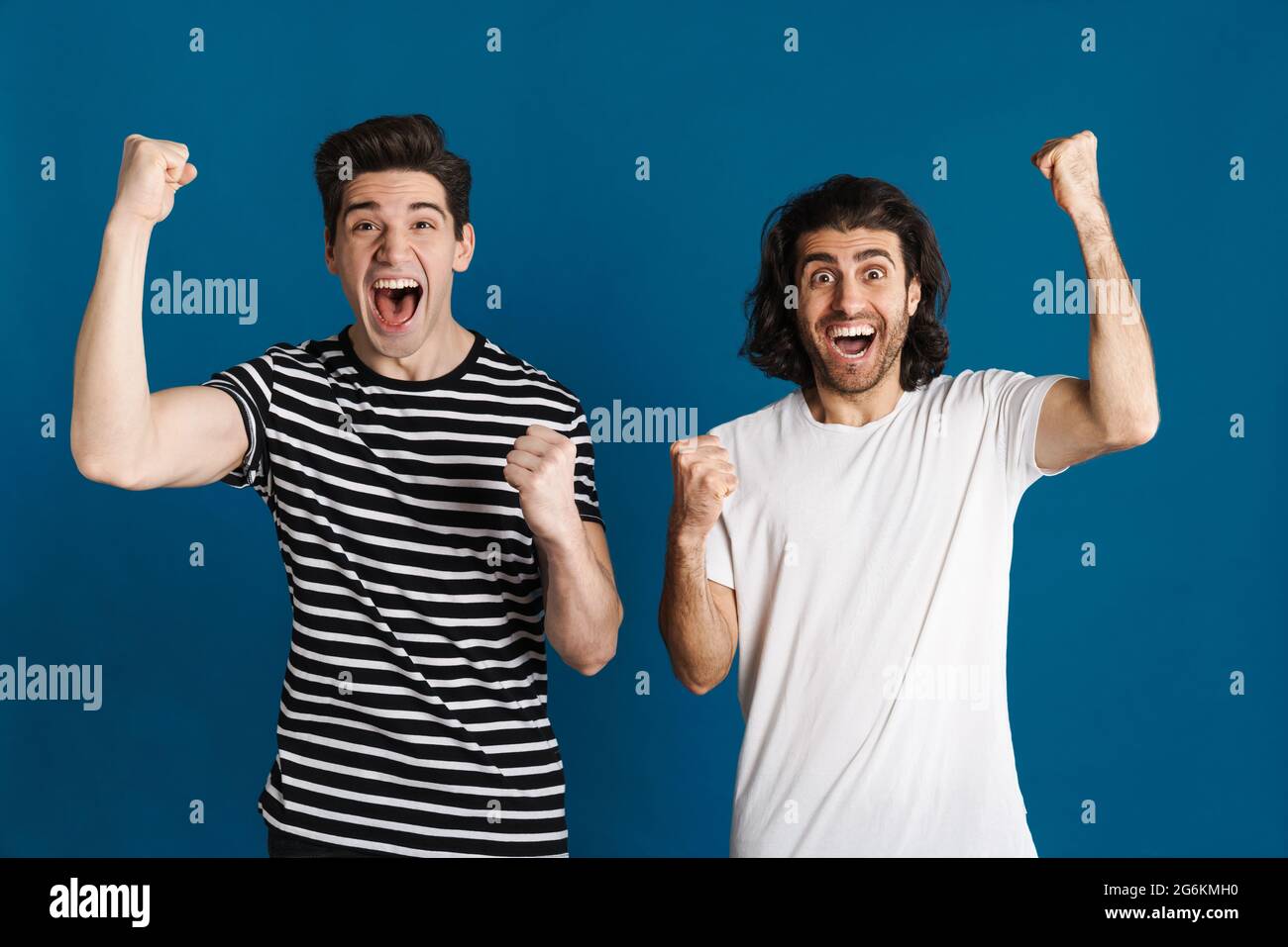 White excited two men exclaiming and making winner gesture isolated ...