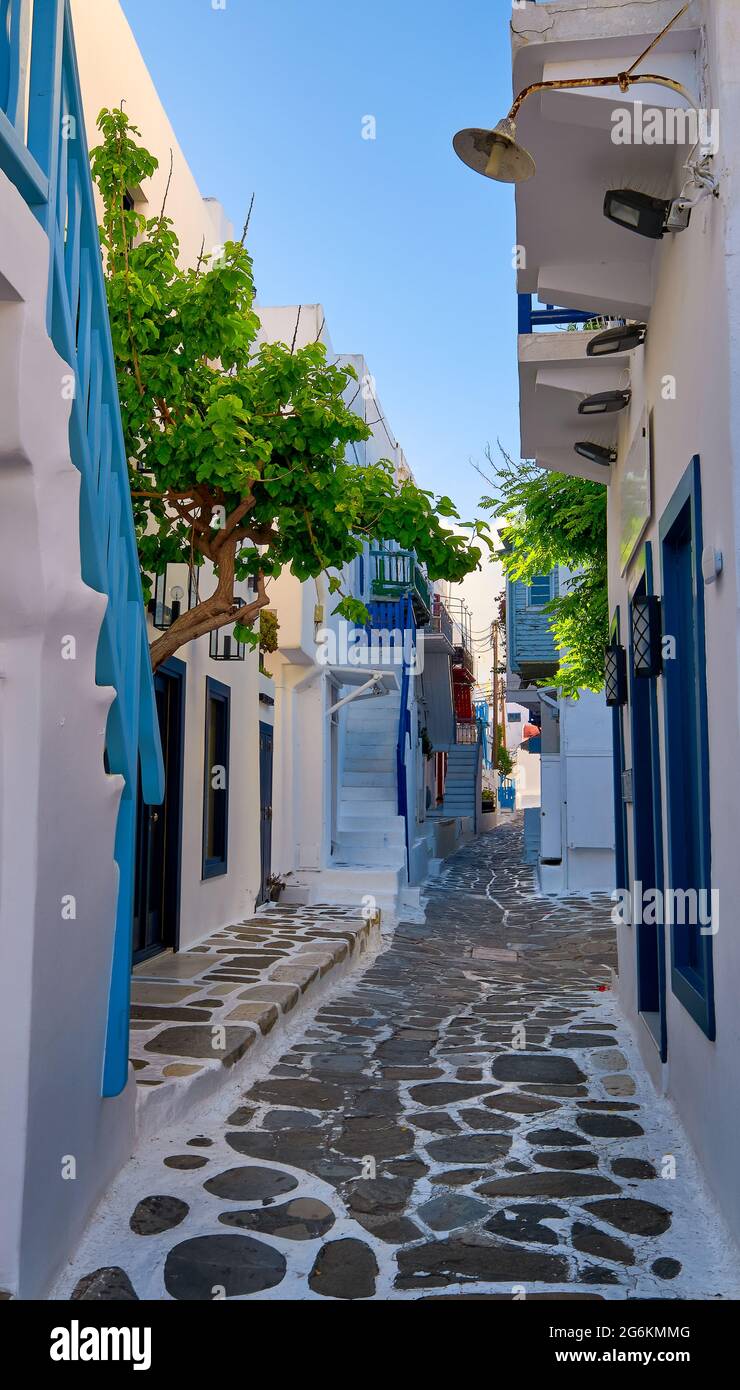 Beautiful traditional alleyways of Greek island towns. White walls, blue balconies and doors ...