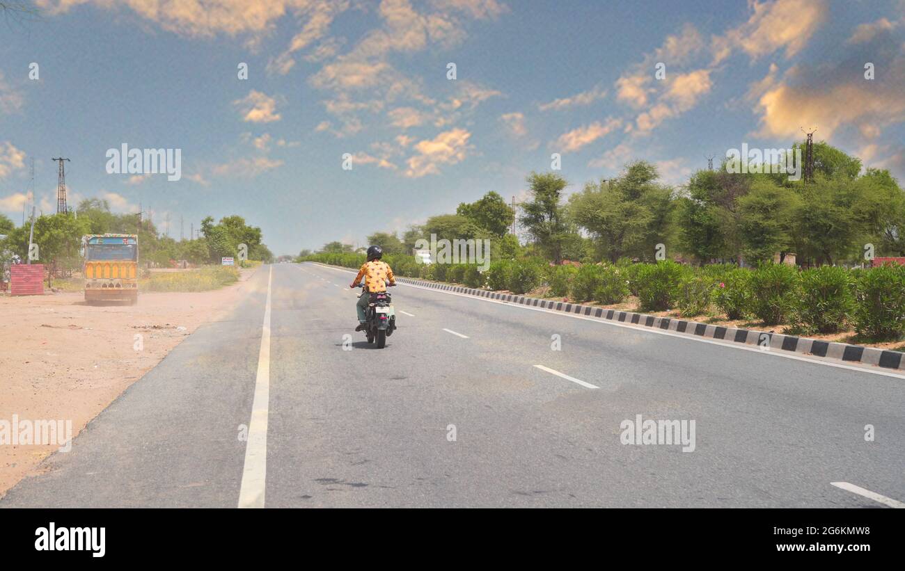 07 July 2021- Reengus, Sikar, India. Motorbike passing through asphalt ...