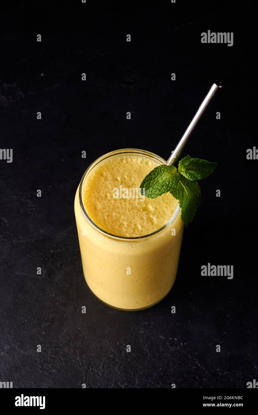 Lassi in glass with tube on dark background vertical orientation ...