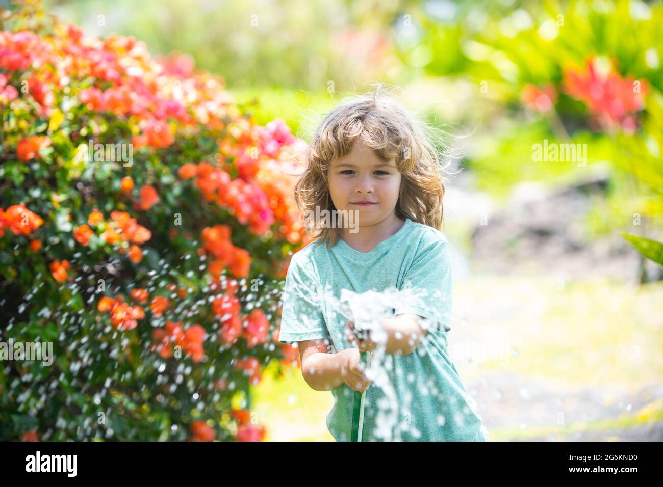 Kids play with water garden hose in yard. Outdoor children summer fun ...