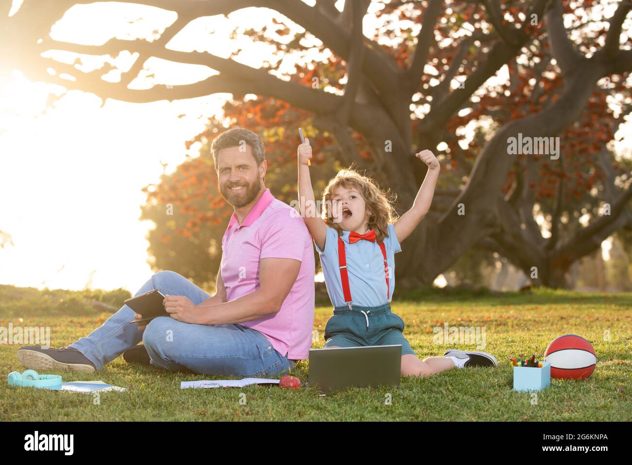 Outdoor learning. Father with son in park, preparing homework ...