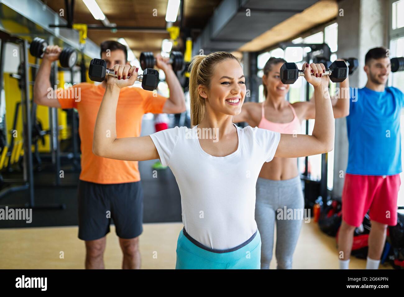 Group of fit young people exercising at the gym Stock Photo - Alamy