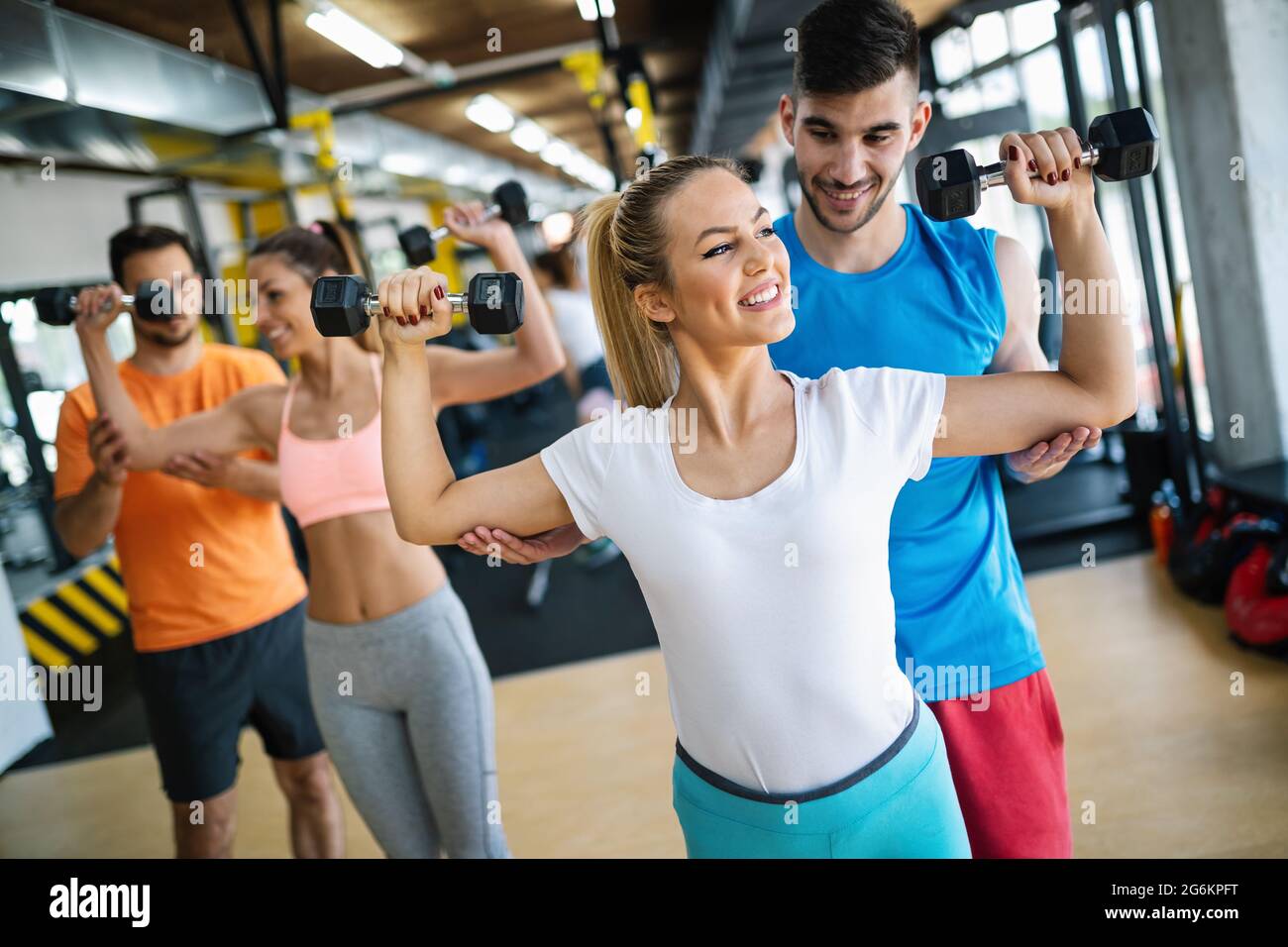 Group of fit young people exercising at the gym Stock Photo - Alamy