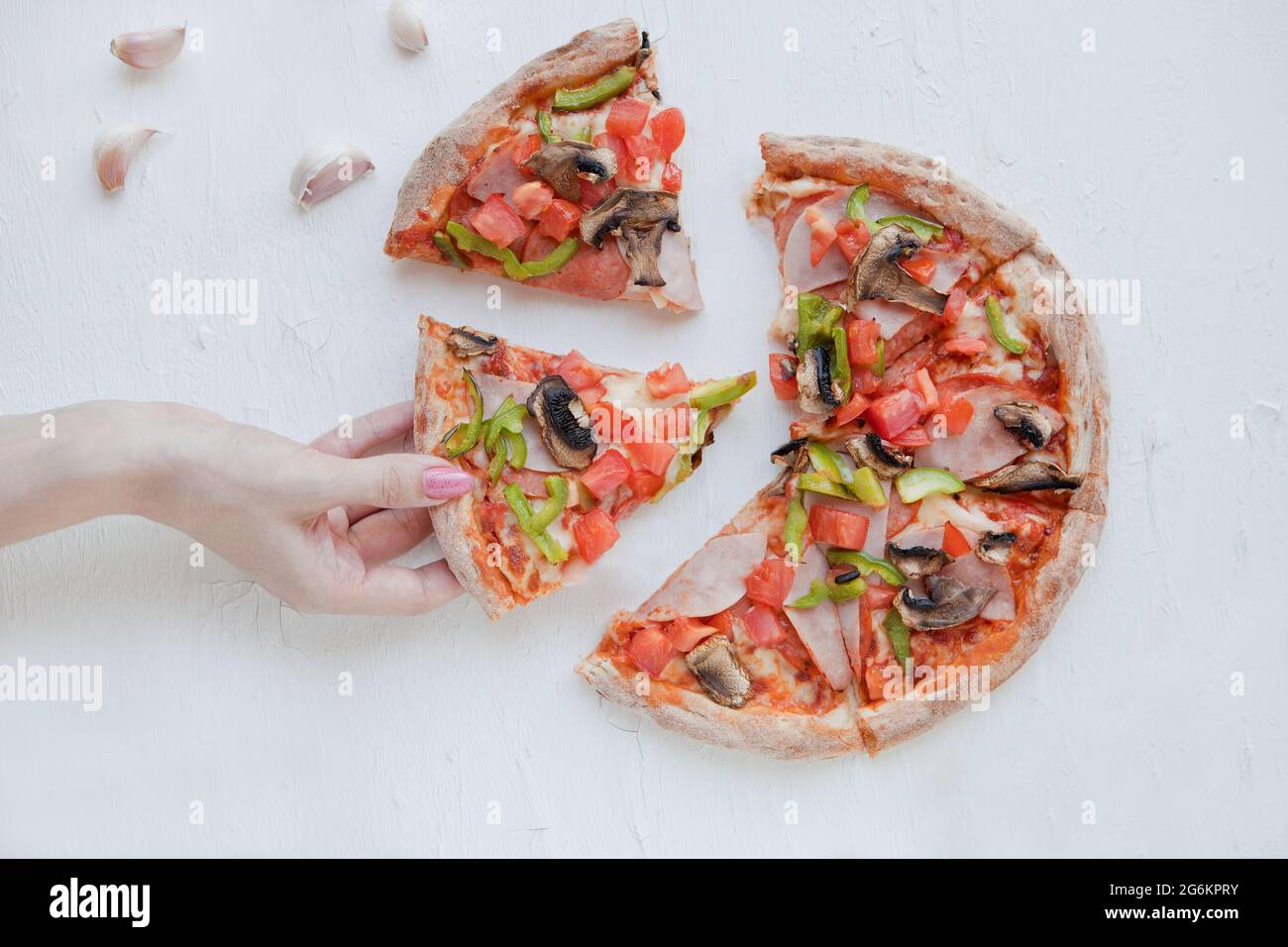 woman hand holding pizza slice. sharing a delicious pizza on a white ...