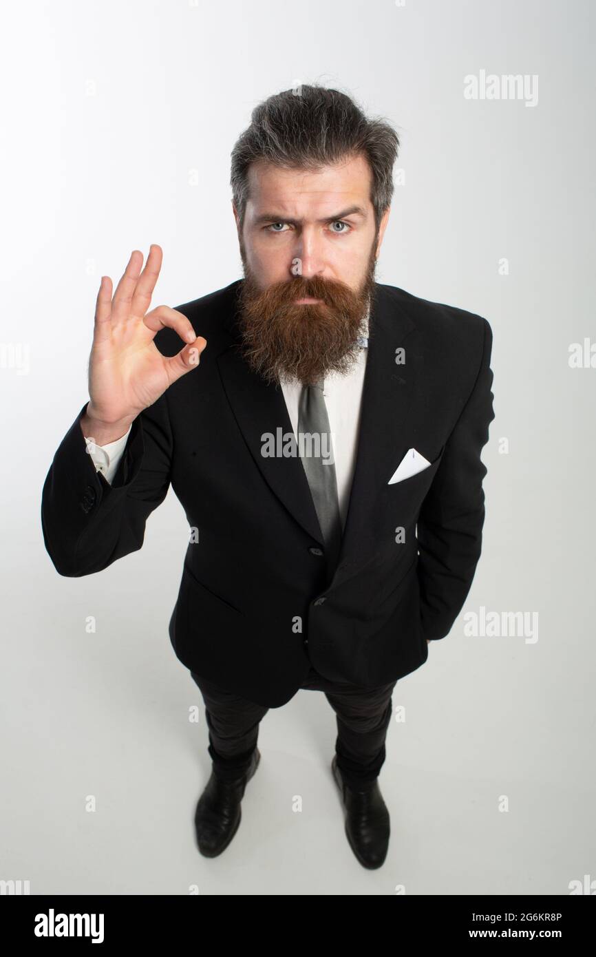 Businessman in suit. Business man in black suit smiling and showing ok ...