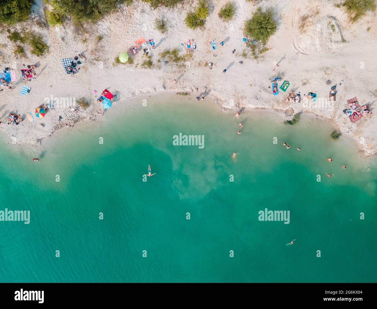 aerial view of people swimming in blue azure water sunbathing resting ...