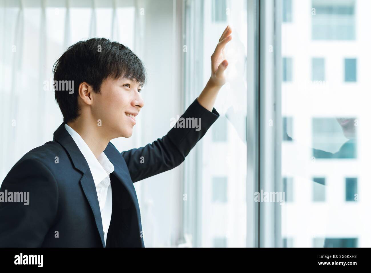 Office building with man looking out window hi-res stock photography ...
