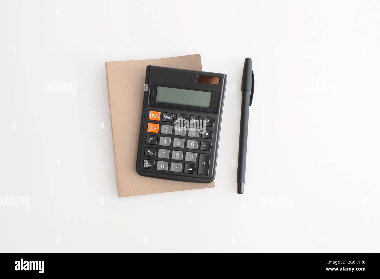 Calculator, notebook and pen on a white background Stock Photo - Alamy
