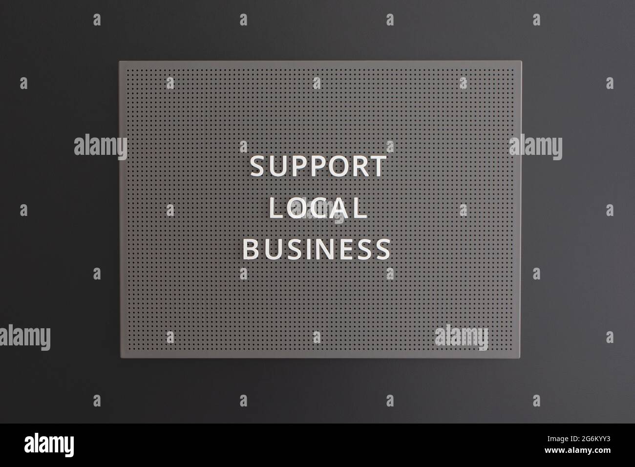 Support Local Business text written on blackboard on black background ...