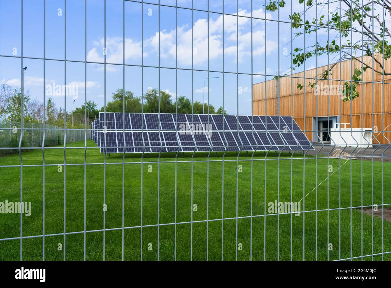 solar panels plant for small eco-friendly facility over the fence view ...