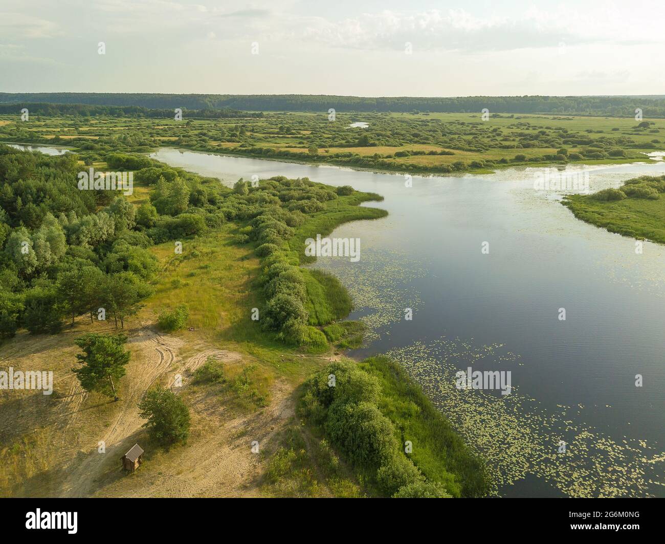 Drone view of the beautiful landscape of the lake, fields, trees on a ...