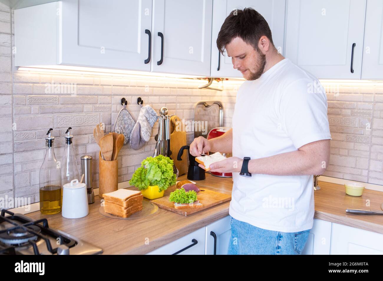 Man making ham sandwich hi-res stock photography and images - Alamy