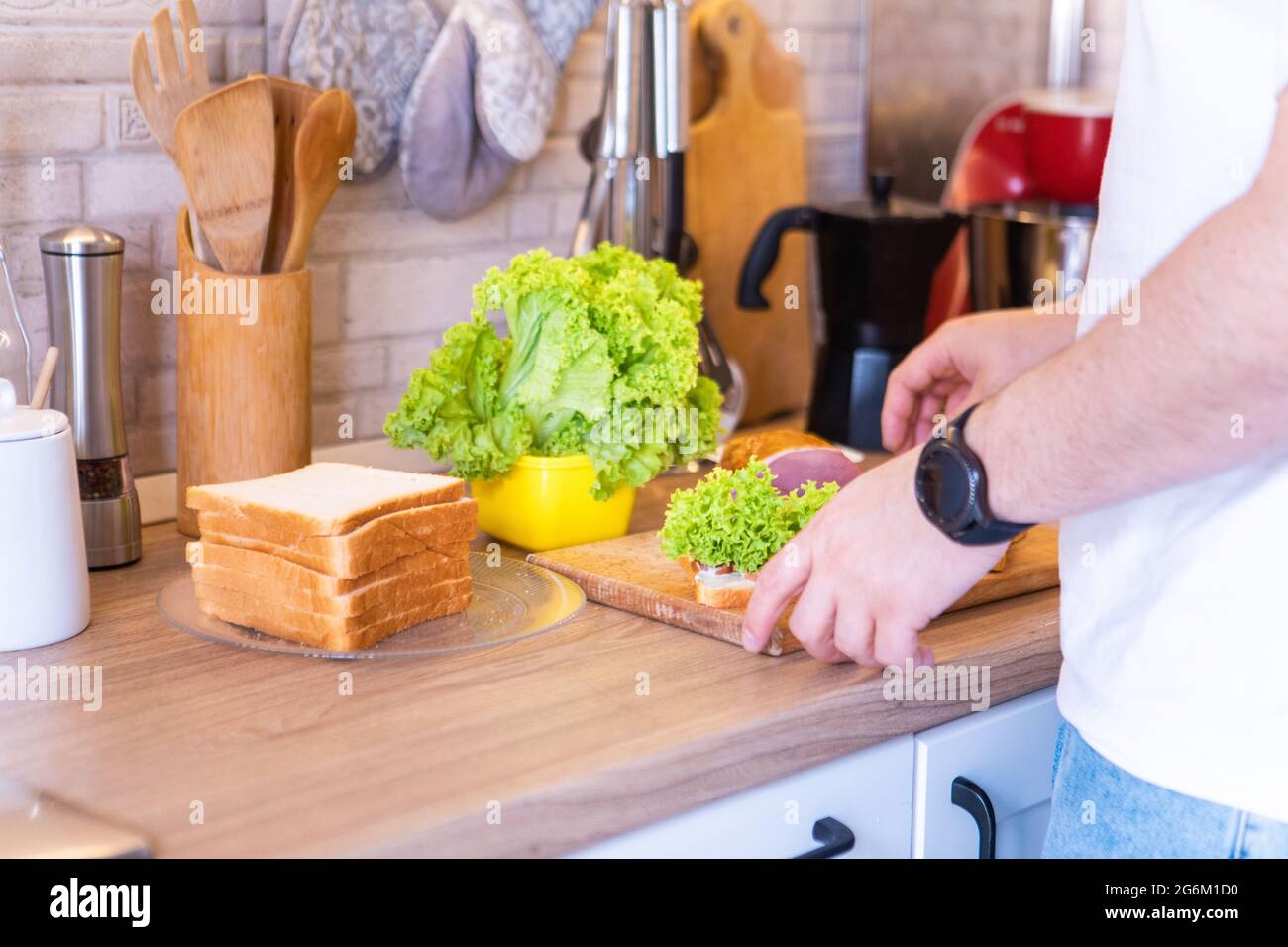 man making sandwich on the kitchen copy space Stock Photo - Alamy